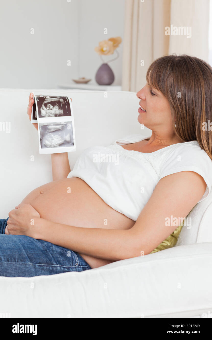 Close up of a pregnant woman looking at her baby's ultrasound scan ...