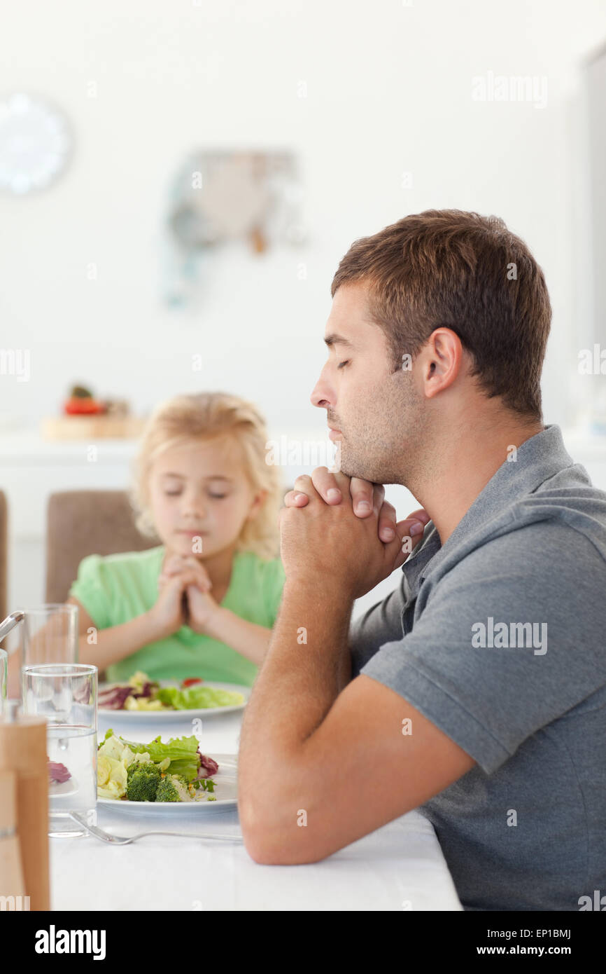 Adorable father and daughter praying during the lunch Stock Photo - Alamy