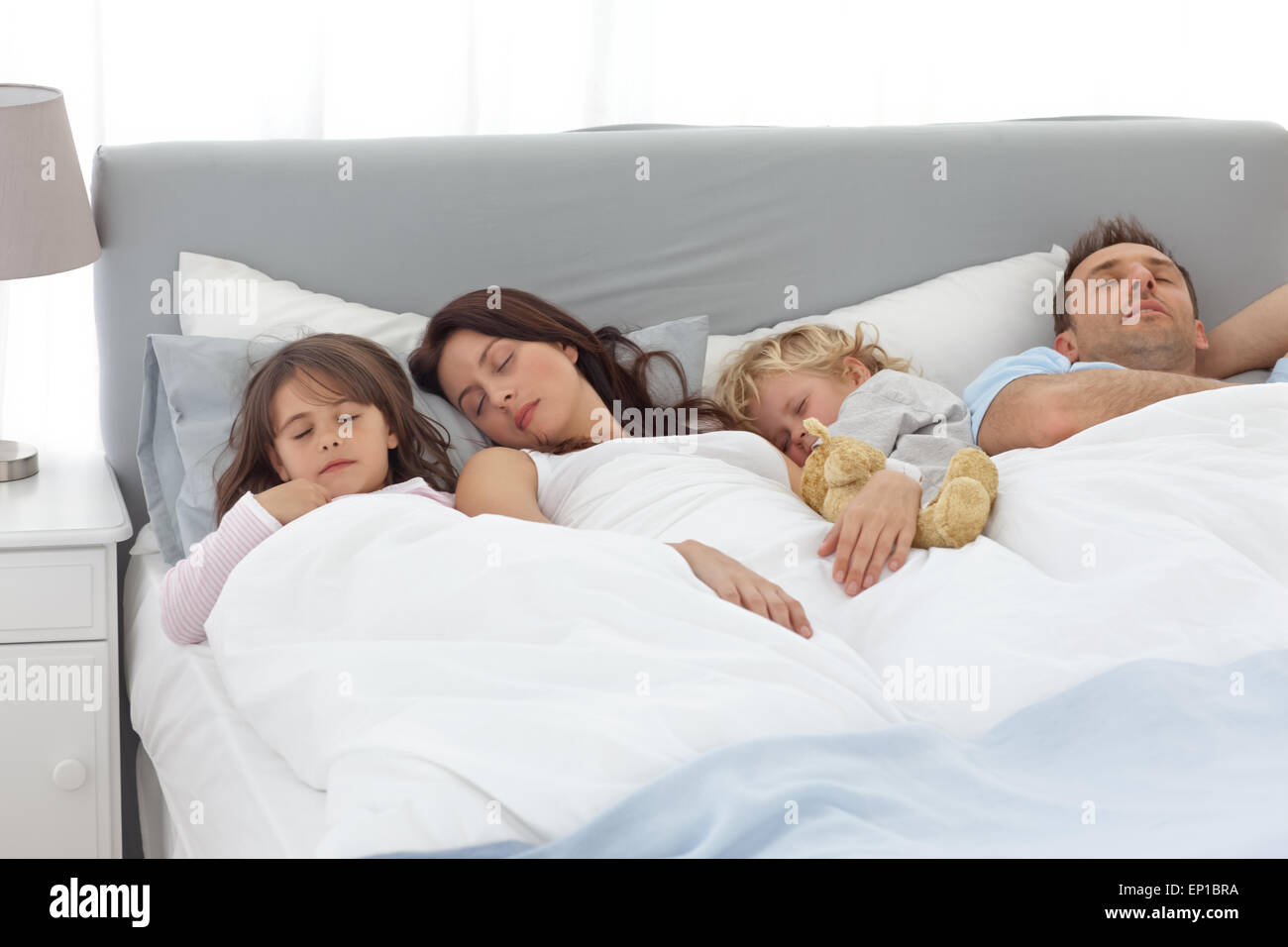 Relaxed family doing a nap together Stock Photo - Alamy