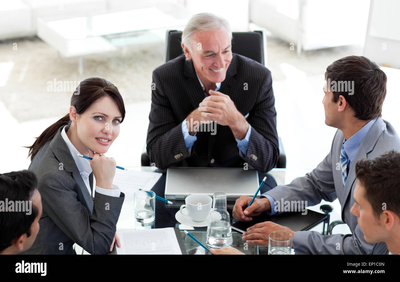 Multi-ethnic business people sitting around a conference table Stock ...