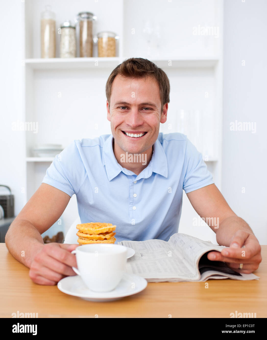 Handsome man reading newspaper during the breakfast Stock Photo - Alamy