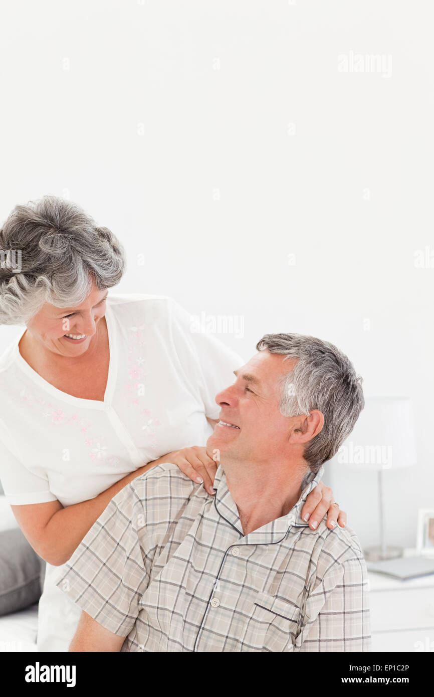 Retired woman giving a massage to her husband at home Stock Photo - Alamy