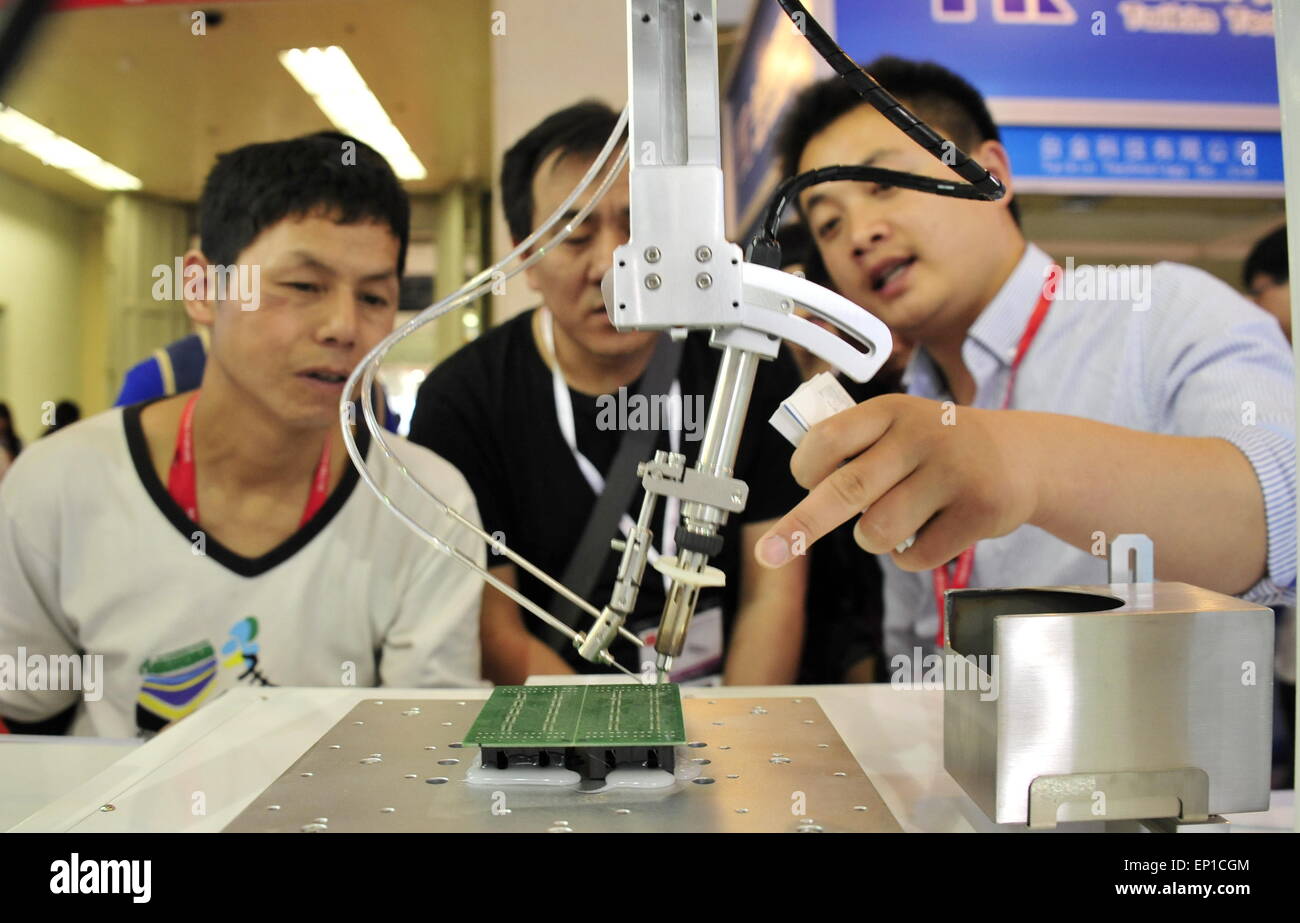 Beijing, China. 13th May, 2015. An exhibitor introduces a minisize ...