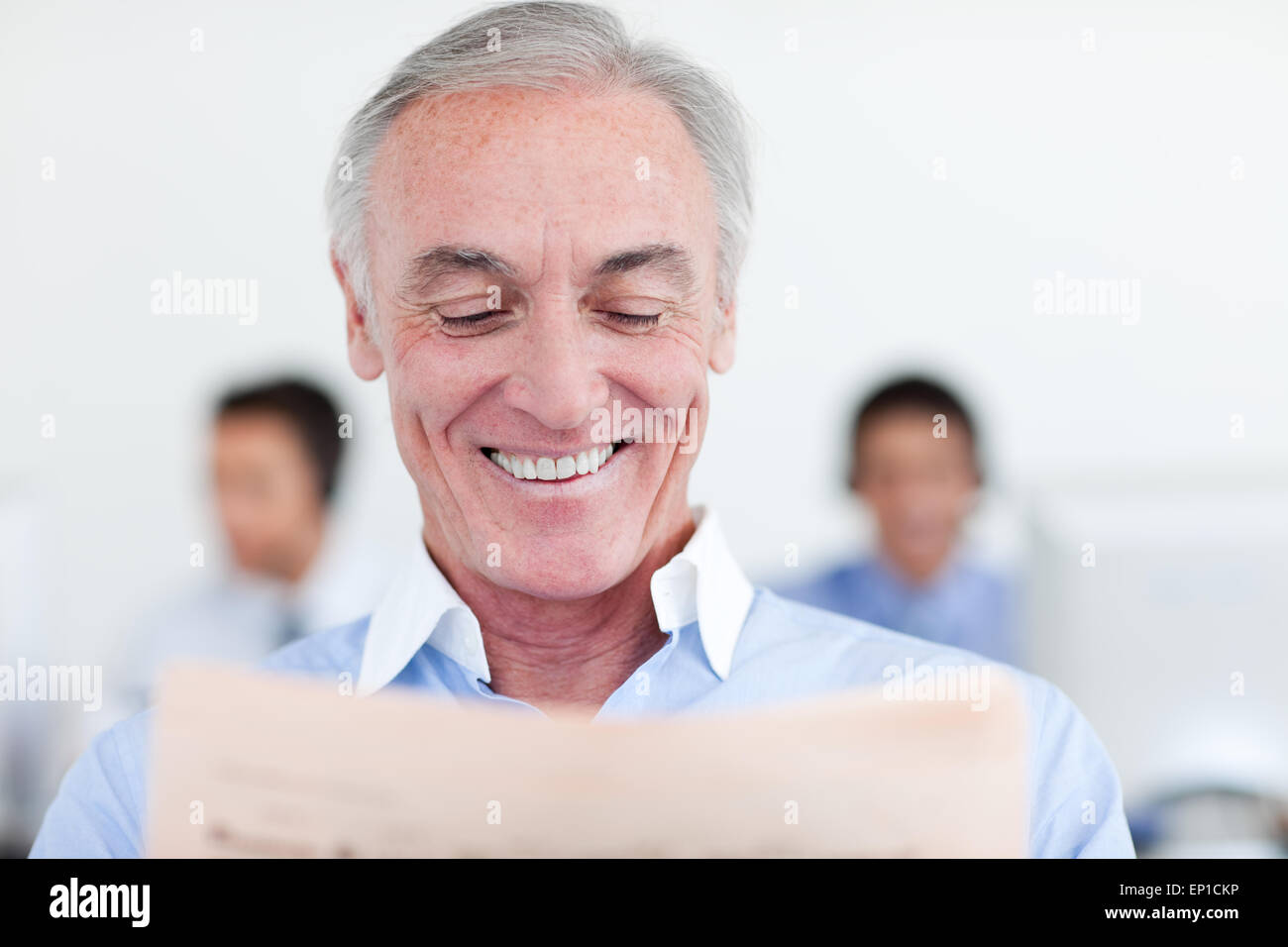 Senior manager reading at his desk Stock Photo - Alamy