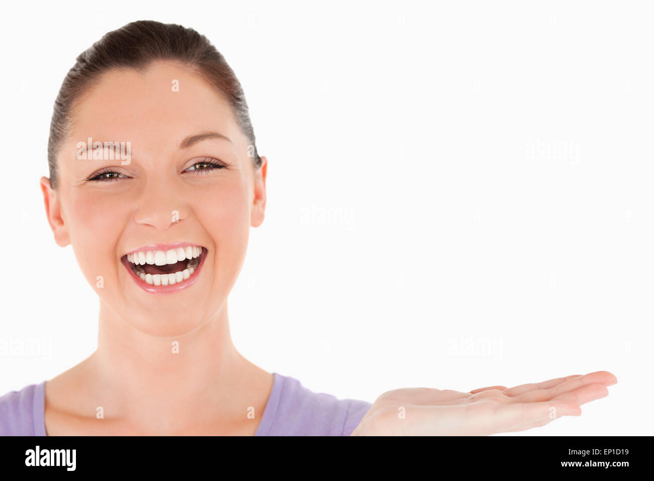 Portrait of a good looking woman showing a copy space while standing ...