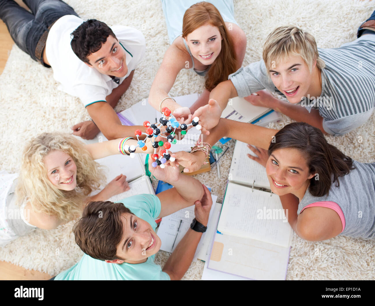 Teenagers studying Science on the floor Stock Photo - Alamy