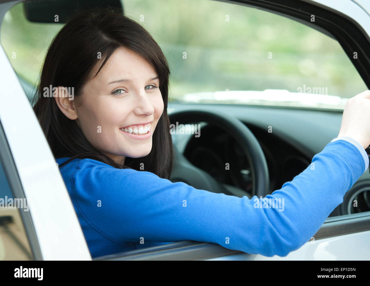 Portrait of a smiling woman driving Stock Photo - Alamy