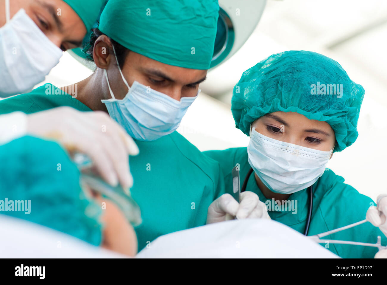 Multi-ethnic surgeons during a surgery Stock Photo - Alamy