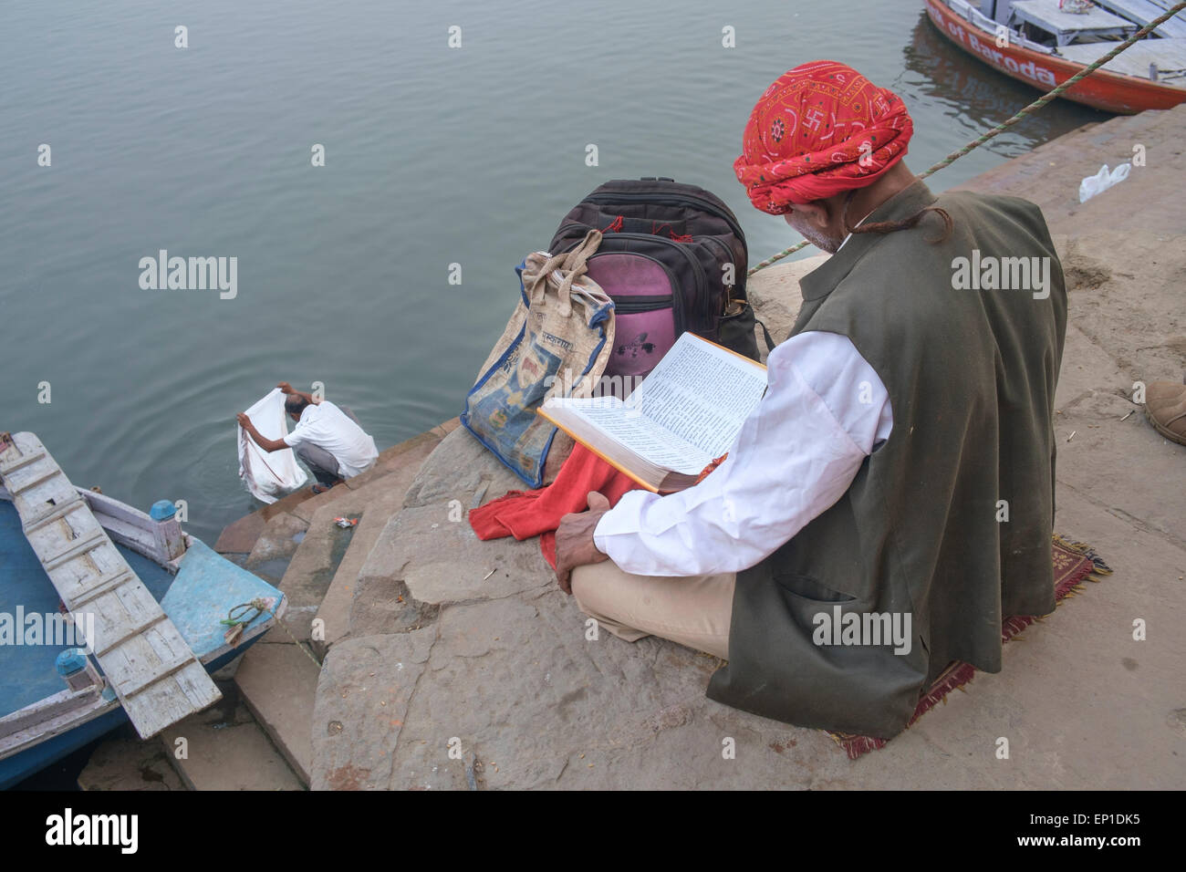 Indian man reading book on hi-res stock photography and images - Alamy