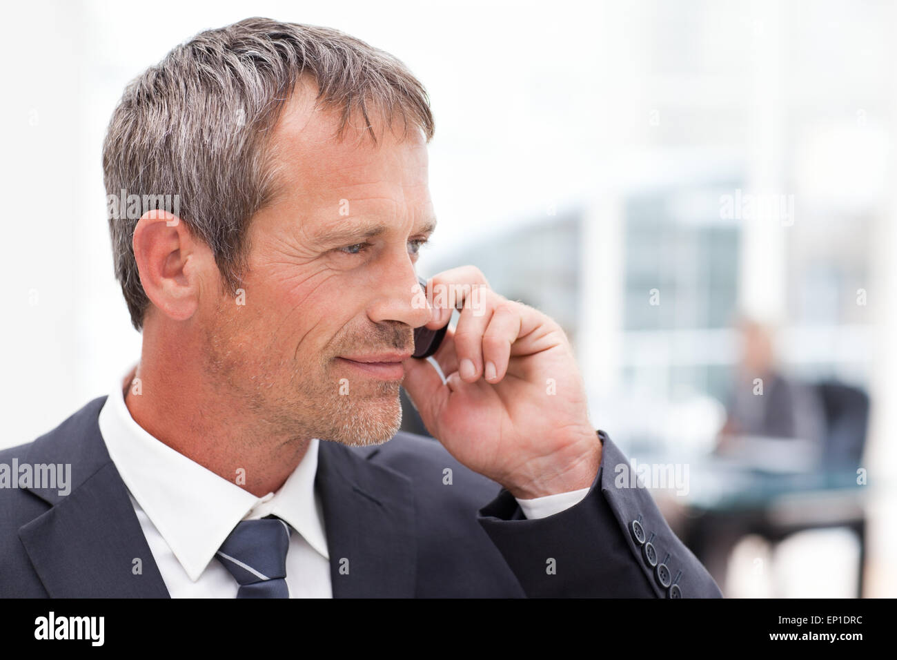 Businessman phoning in his office Stock Photo - Alamy
