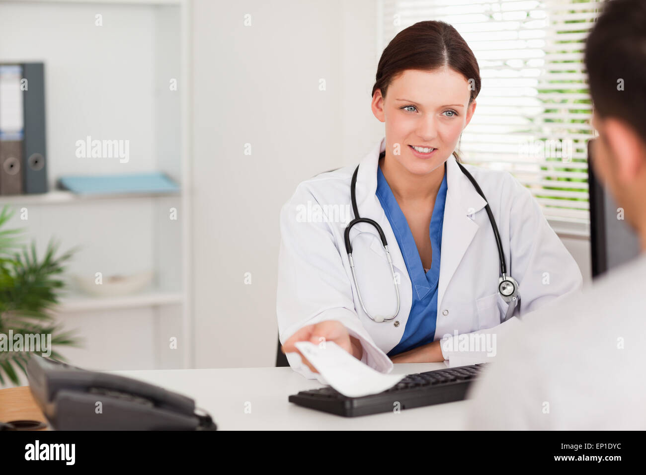 Female doctor giving patient prescription Stock Photo - Alamy