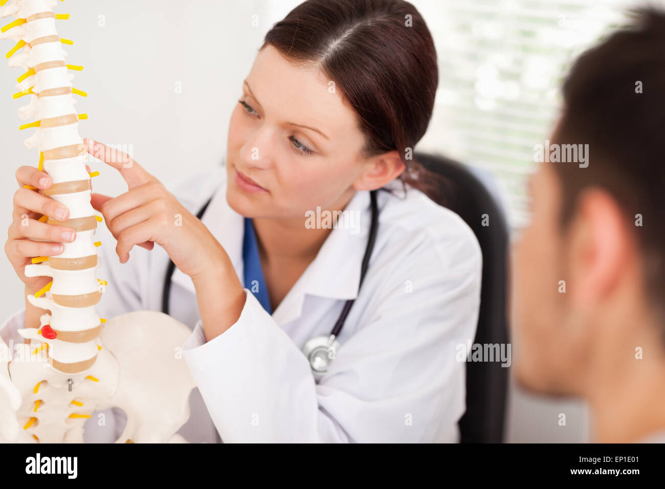 Female doctor showing patient a bone Stock Photo - Alamy