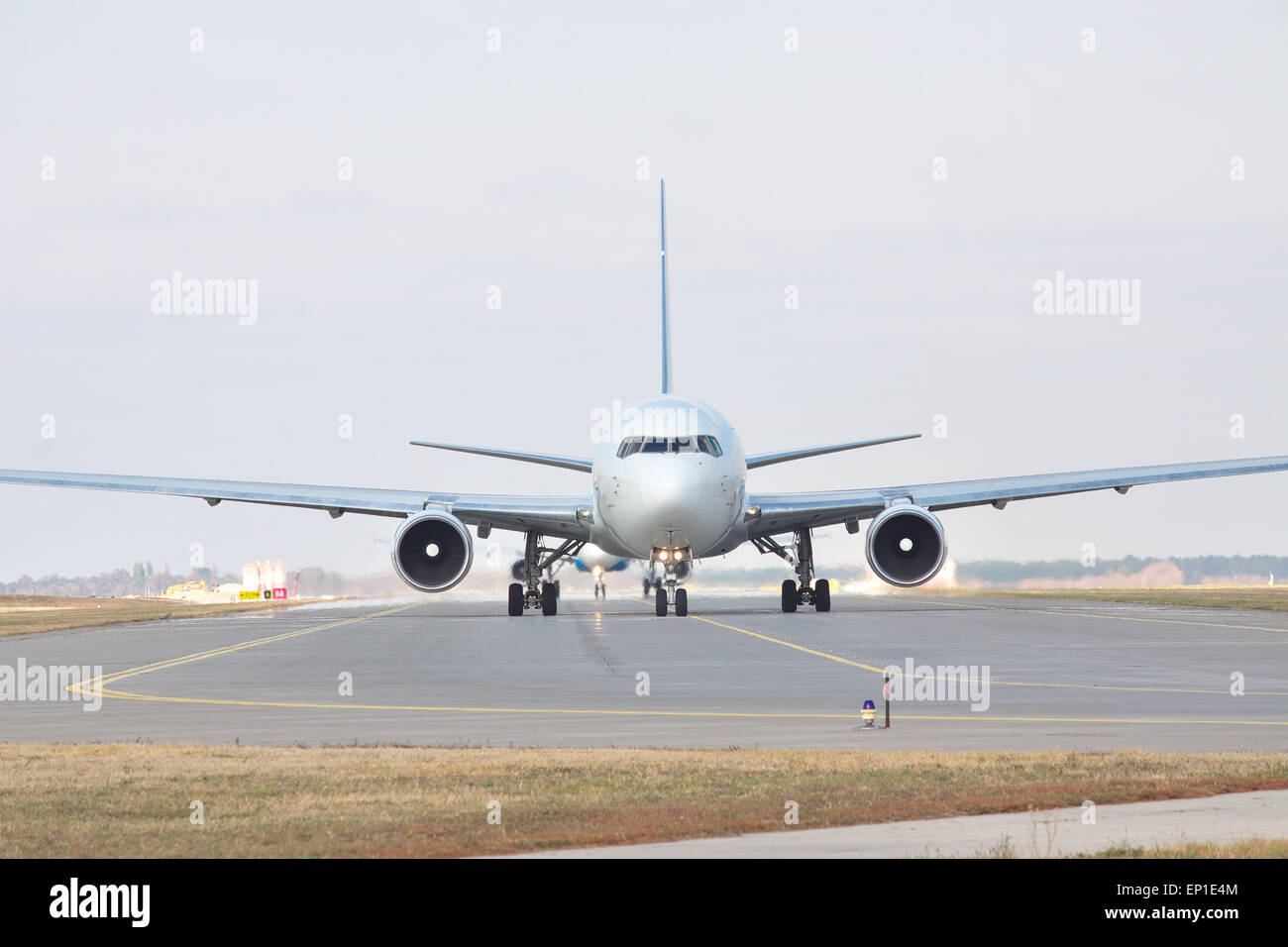 Passenger jet plane on the runway in the airport (front view Stock ...