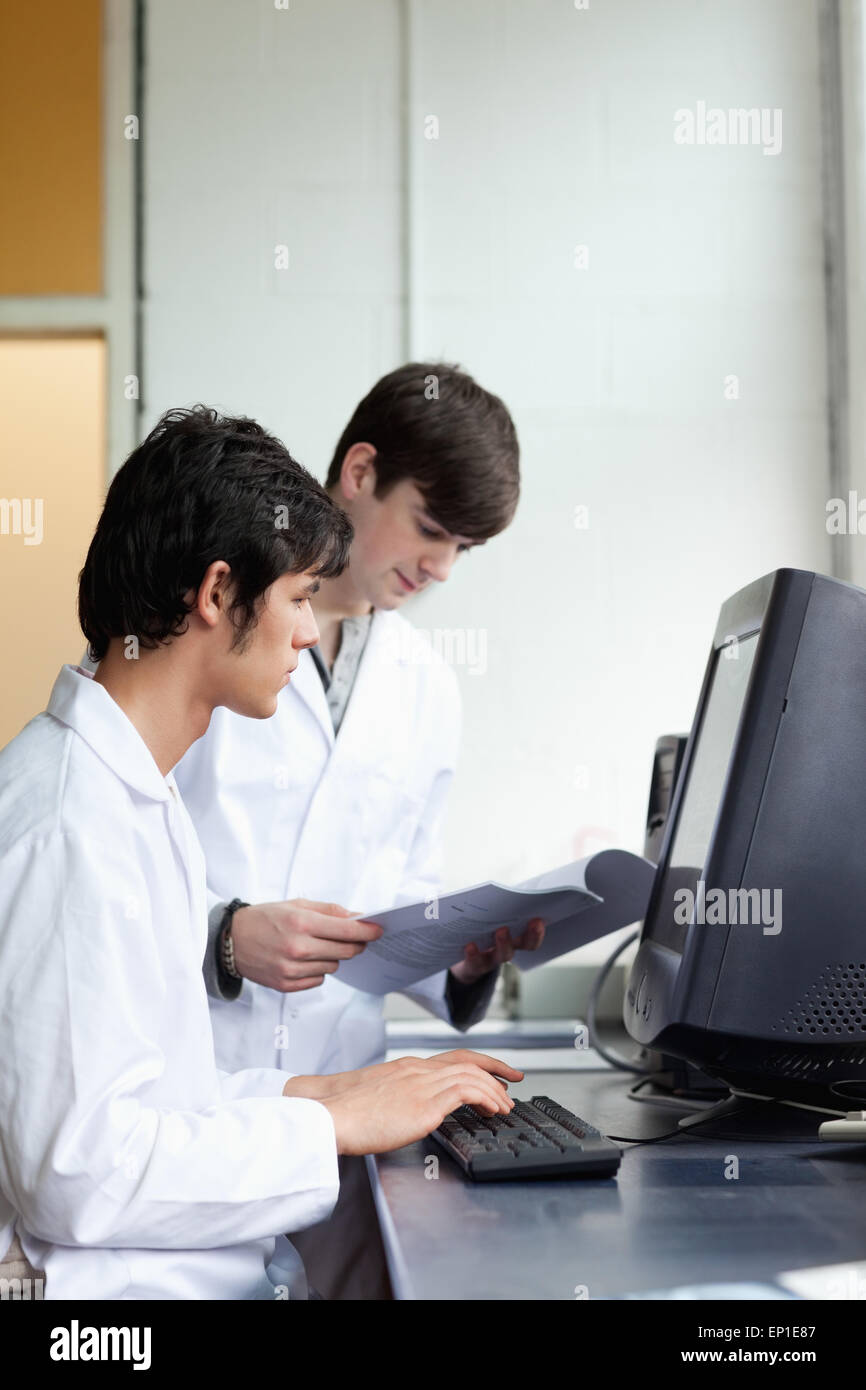 Male scientists using a monitor Stock Photo - Alamy