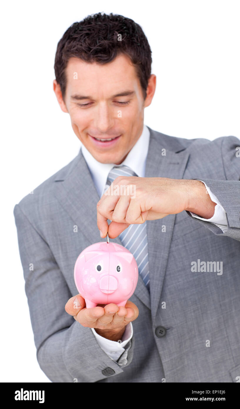 Smiling businessman saving money in a piggybank Stock Photo - Alamy