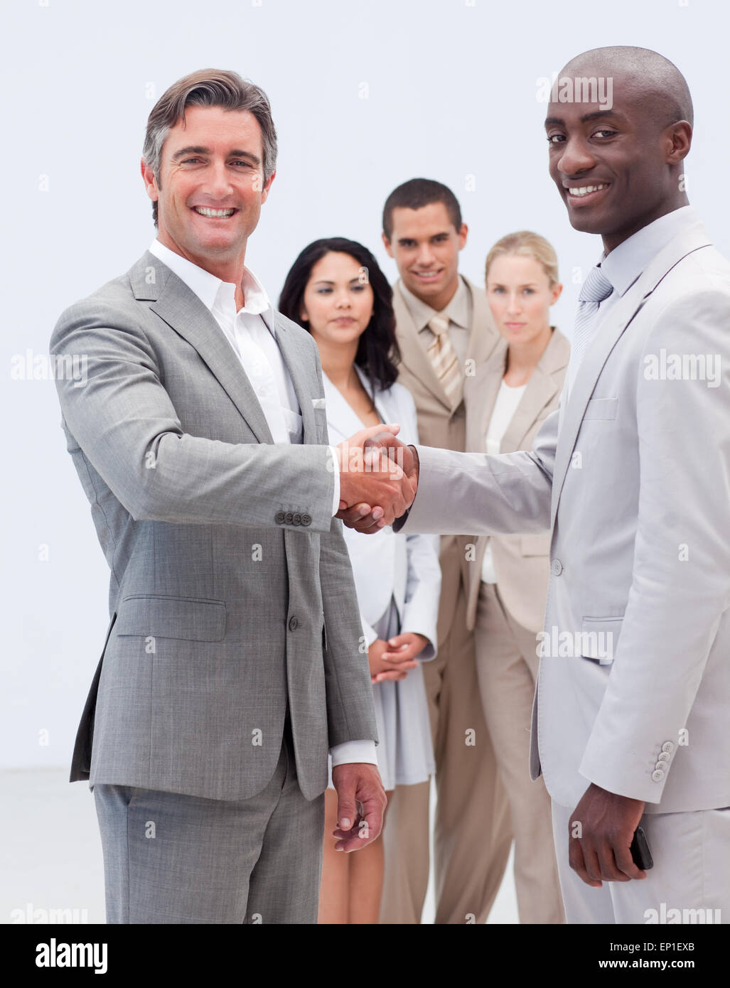 Smiling businessmen shaking hands Stock Photo - Alamy