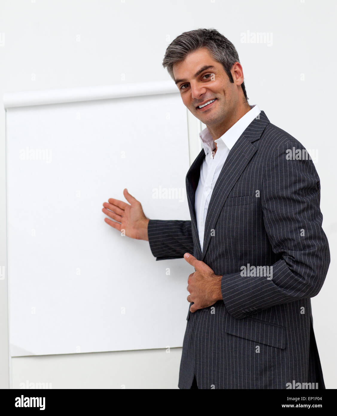 Self-assured male executive pointing at a board Stock Photo - Alamy