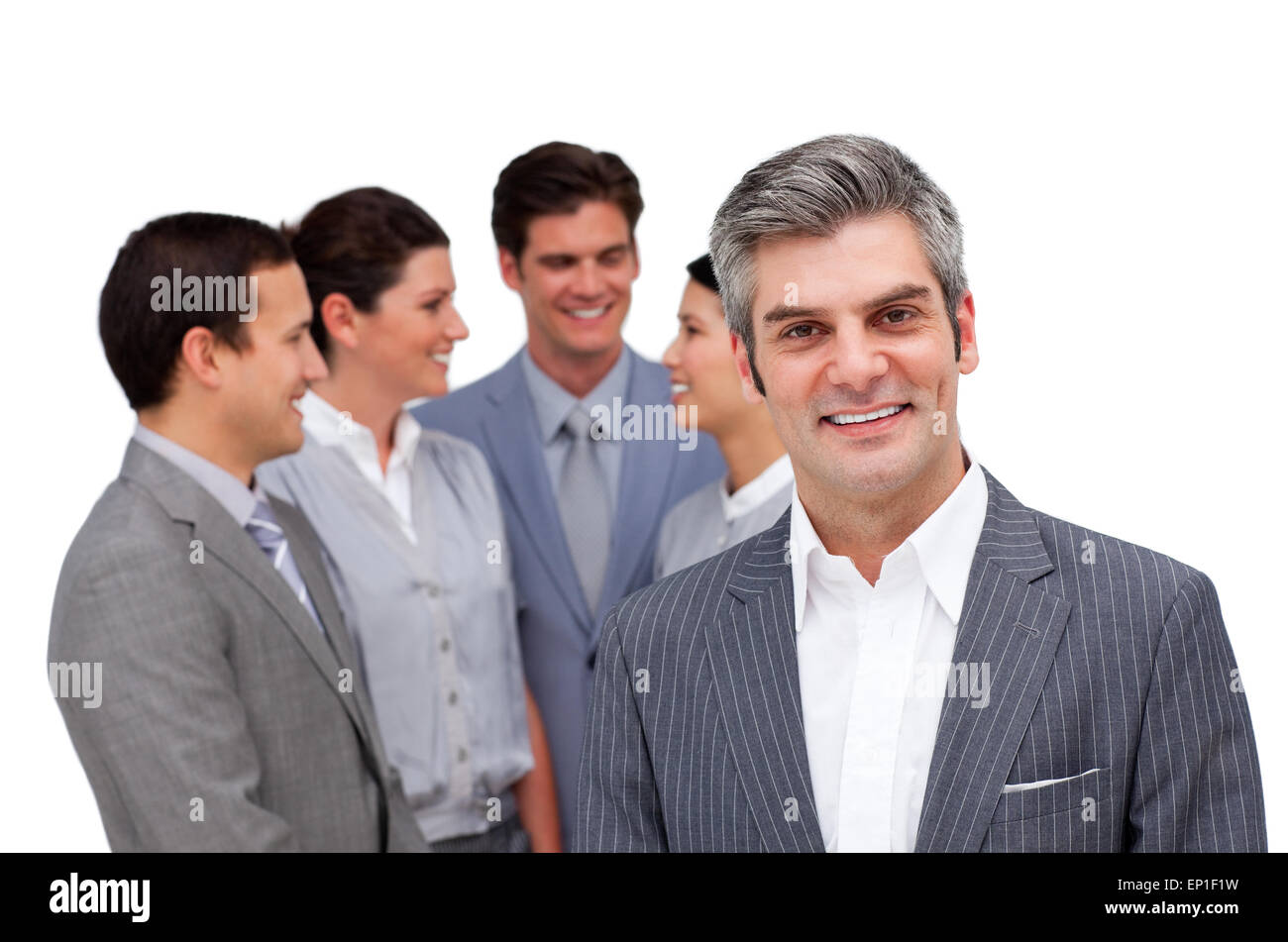 Mature manager standing with his team against a white background Stock ...