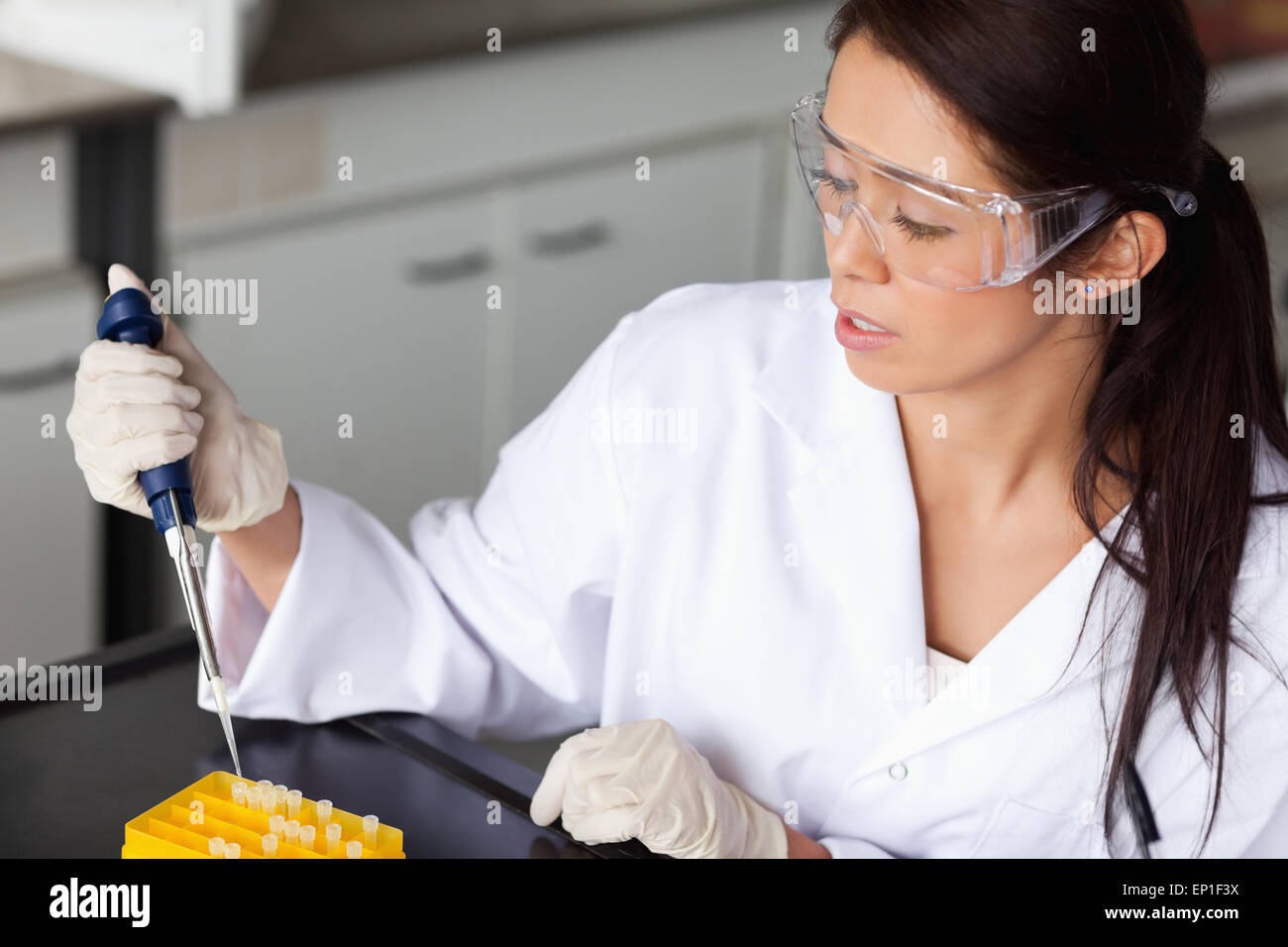 Brunette woman making an experiment Stock Photo - Alamy