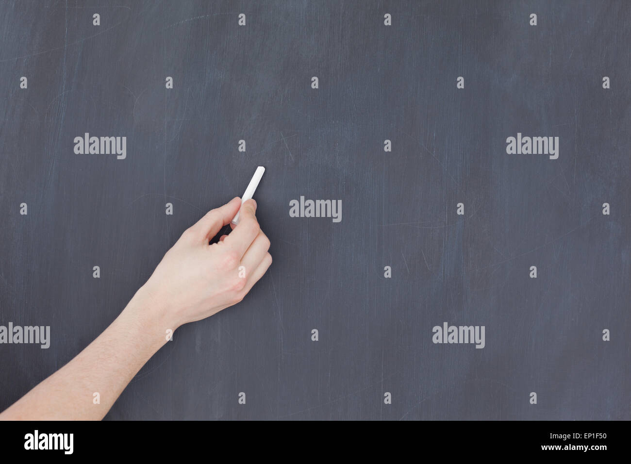 Hand holding a chalk and and ready to write on a blackboard Stock Photo ...