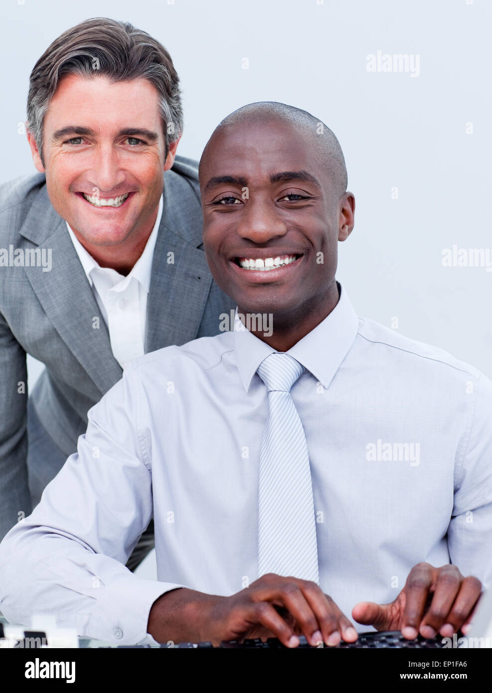 Male colleagues helping ethnic hi-res stock photography and images - Alamy