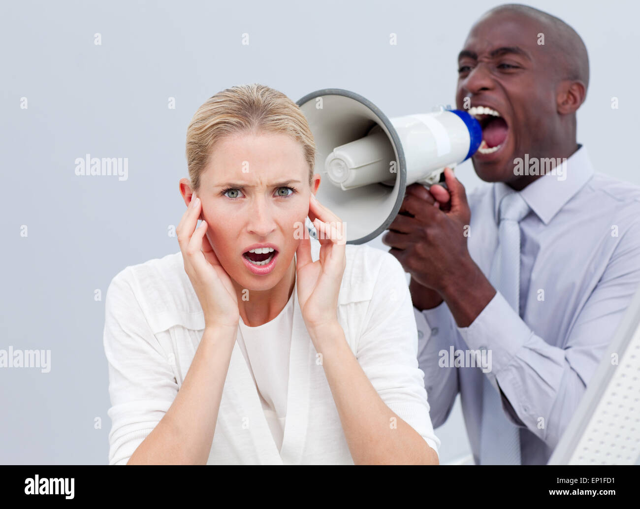 Furious businessman shouting through a megaphone Stock Photo - Alamy