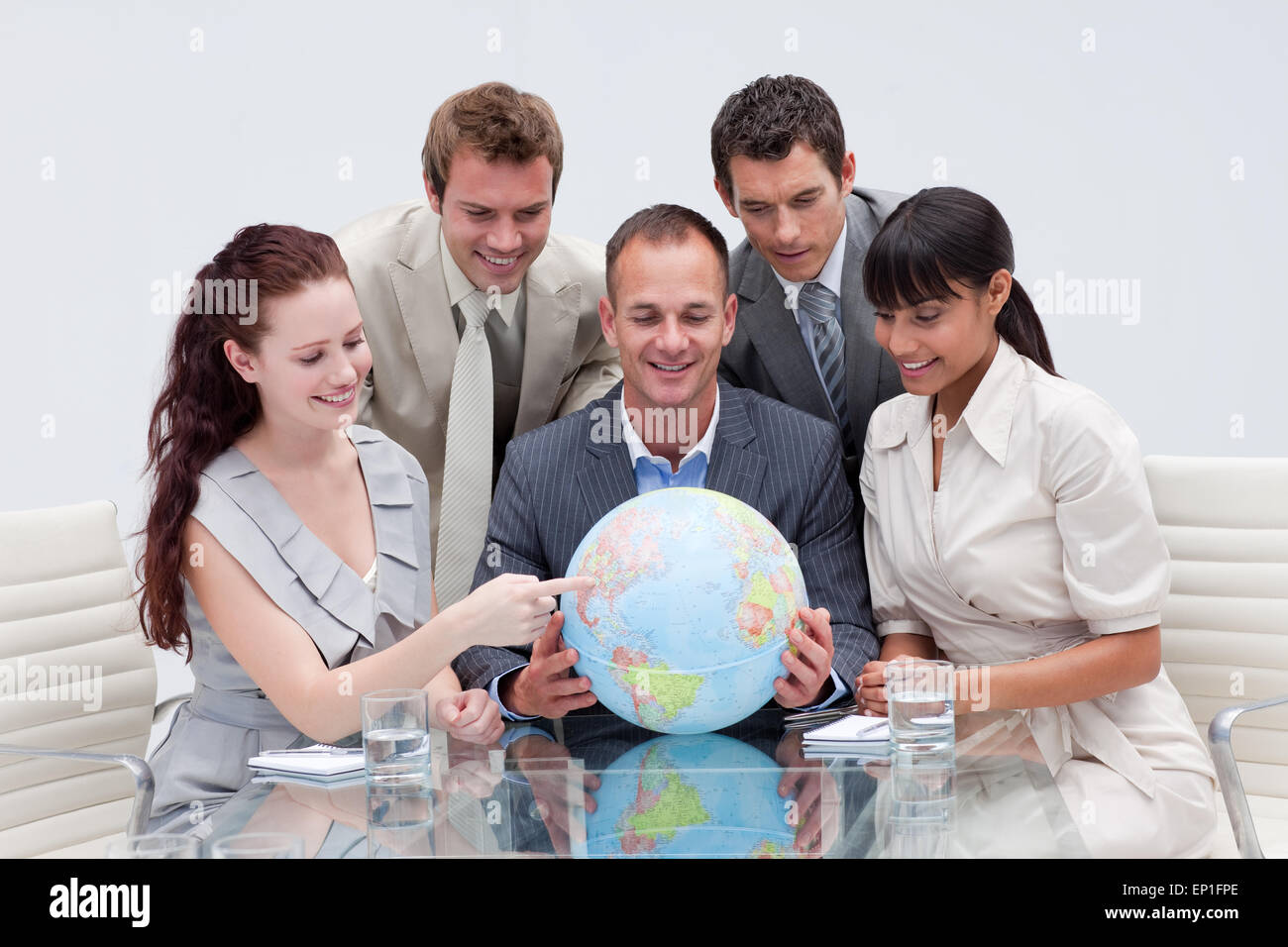 Business team holding a terrestrial globe. International business Stock ...