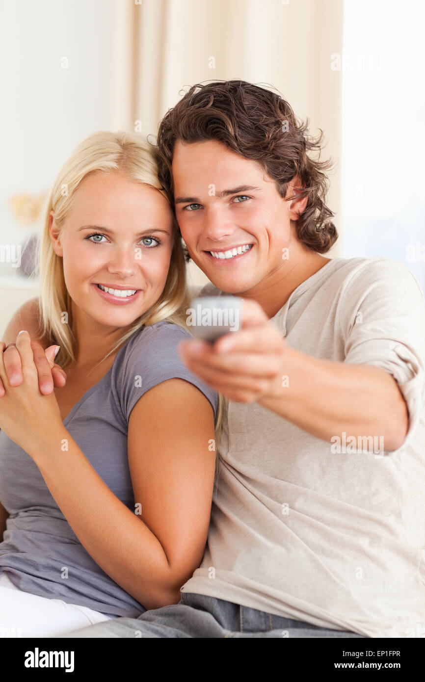 Portrait of a cute couple watching TV Stock Photo - Alamy