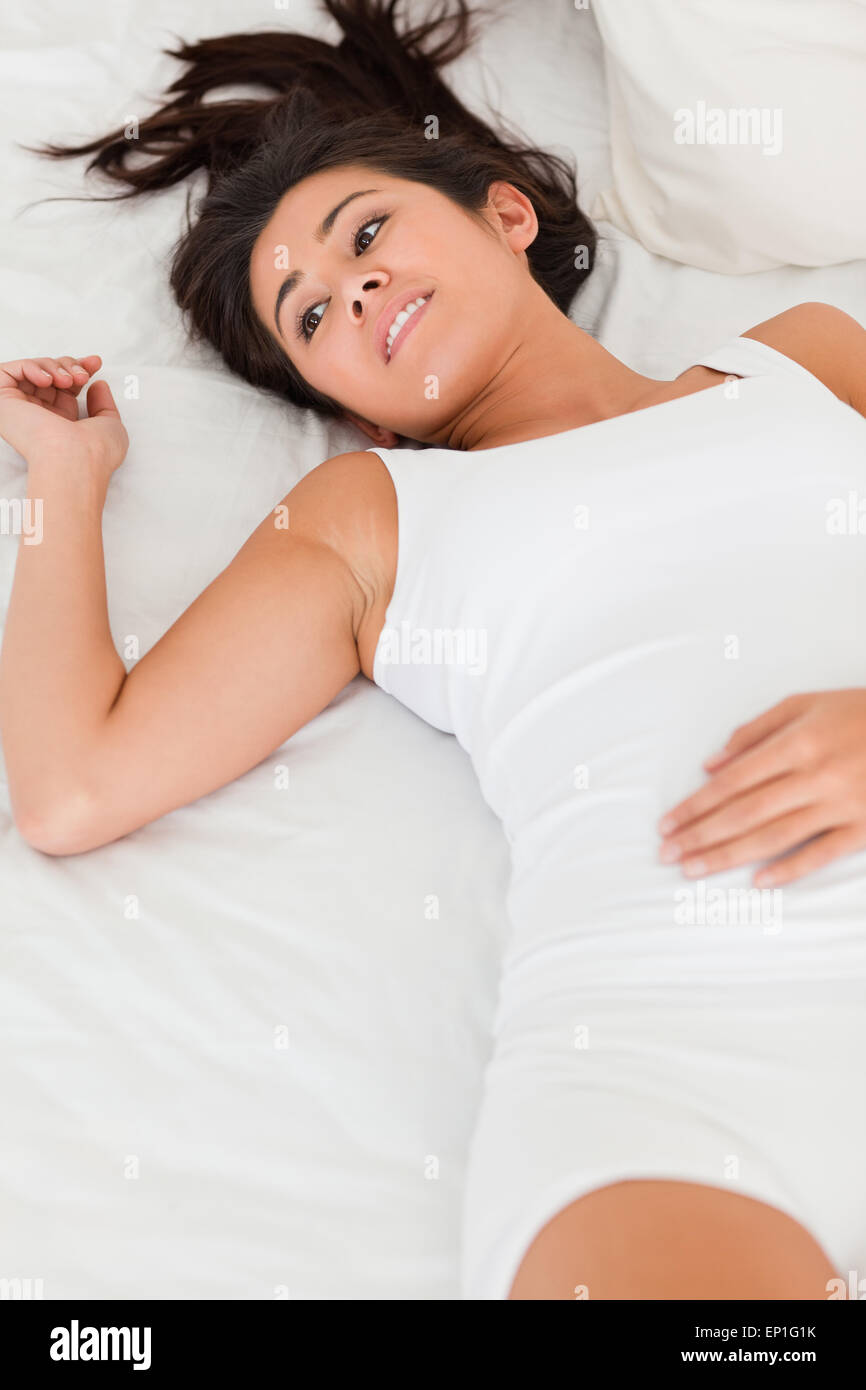 relaxing smiling woman lying on bed Stock Photo - Alamy