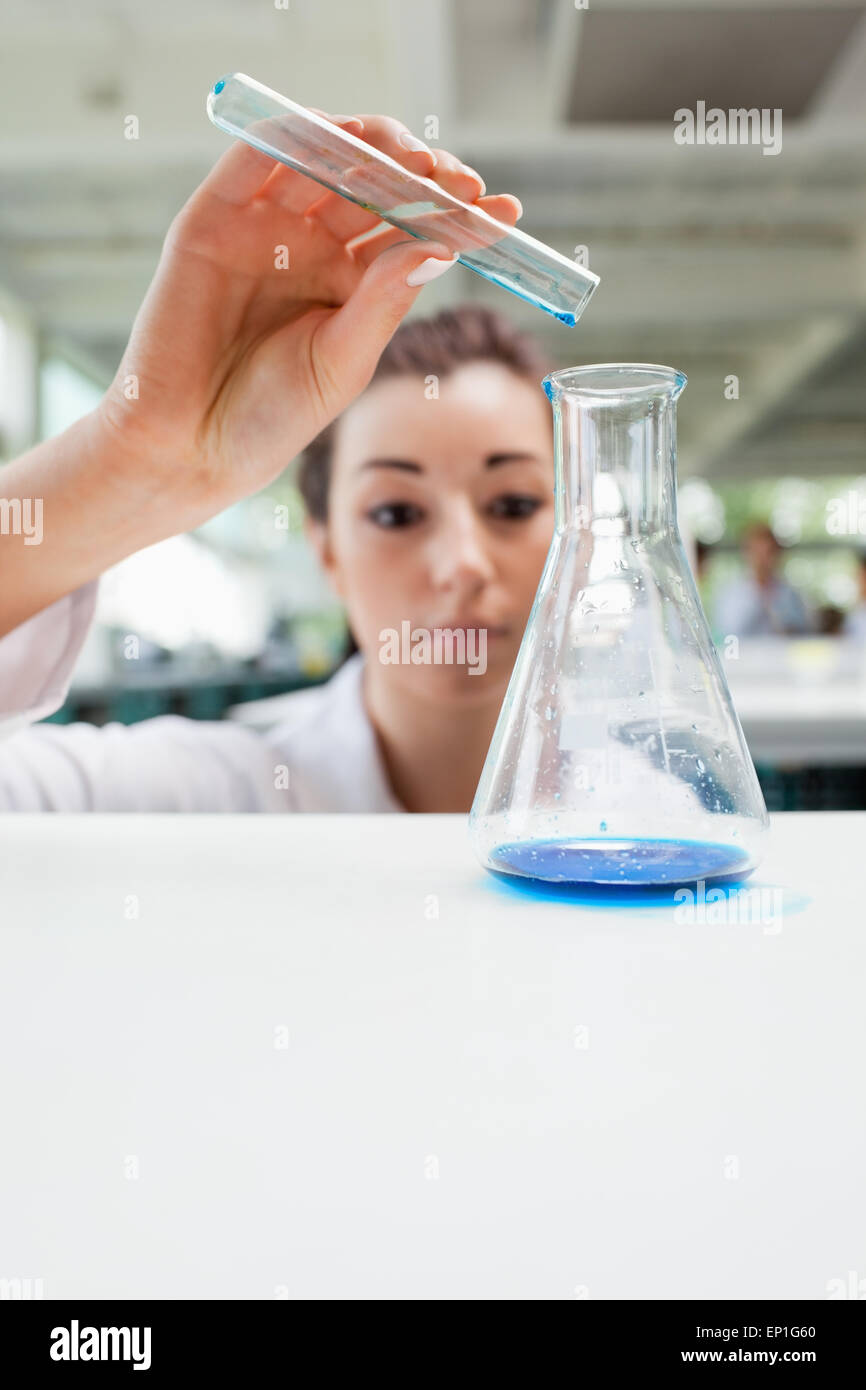 Portrait of a serious science student pouring liquid Stock Photo - Alamy