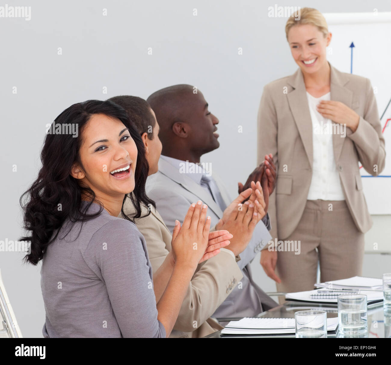 Businesswoman standing smilling after a presentation Stock Photo - Alamy
