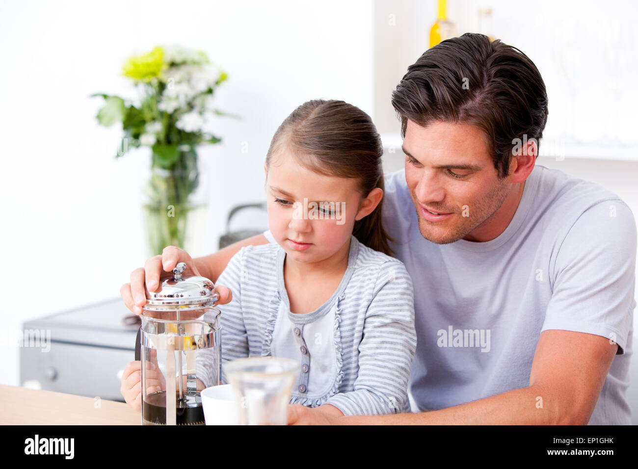 Attentive father and his daughter having breakfast together Stock Photo ...