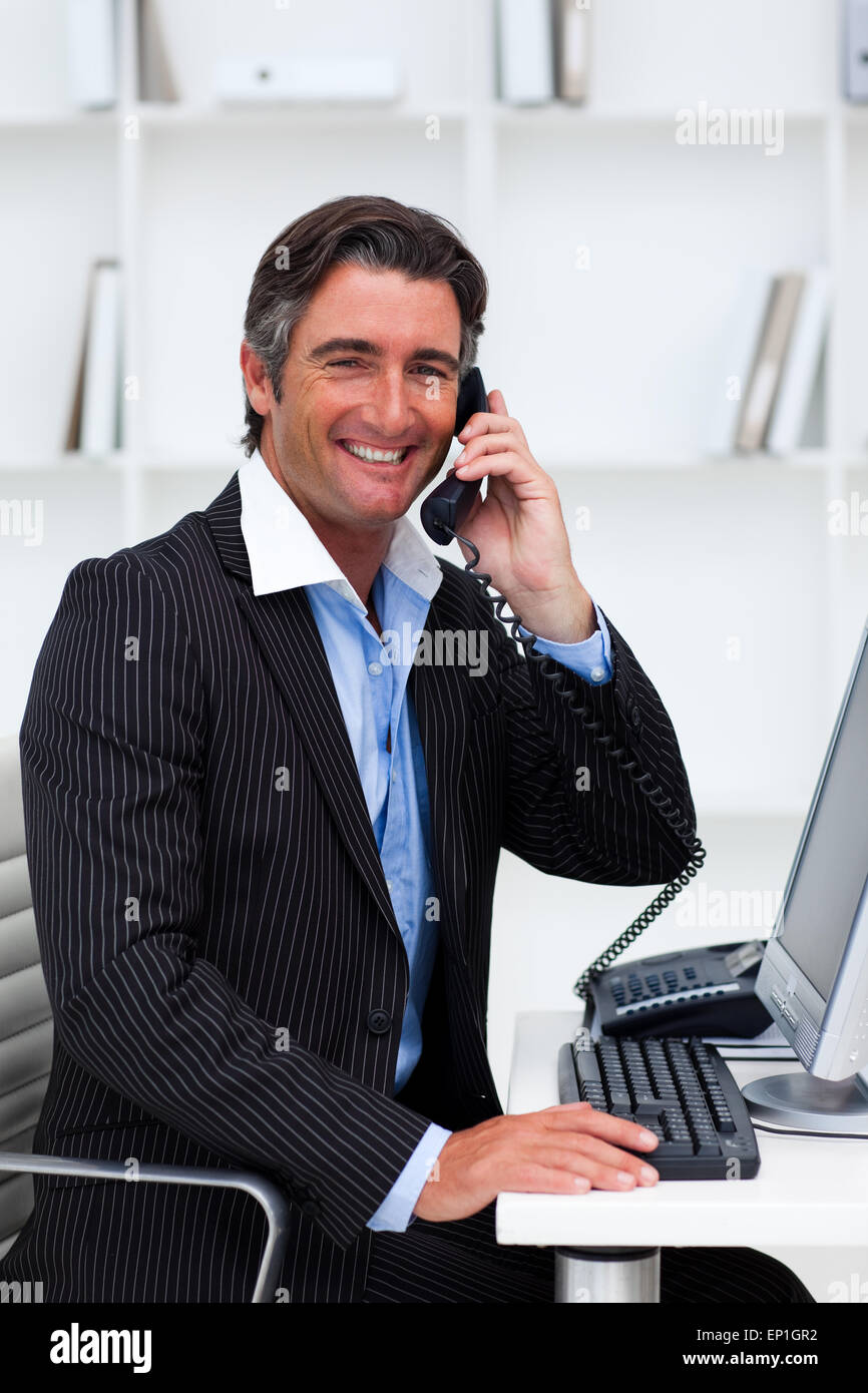 Confident businessman talking on phone Stock Photo - Alamy