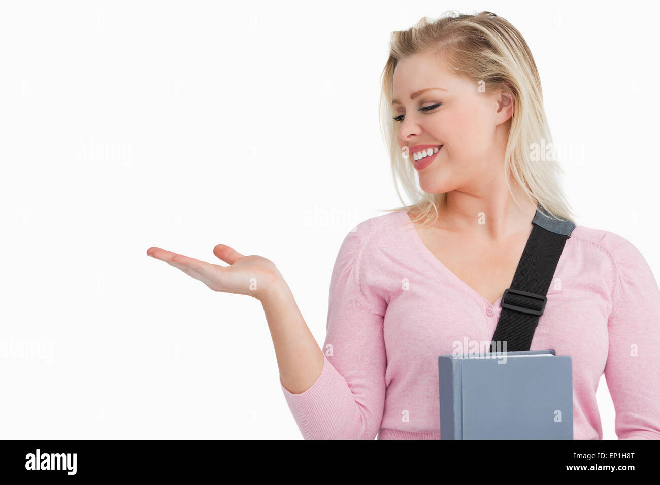 Cheerful blonde woman extending her hand palm Stock Photo - Alamy