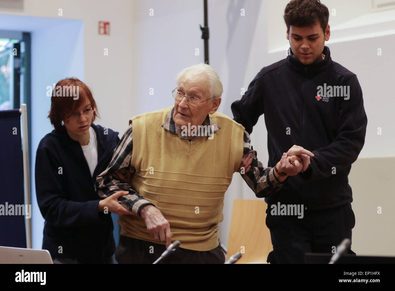Workers from the German Red Cross bring the SS officer Oskar Groening ...