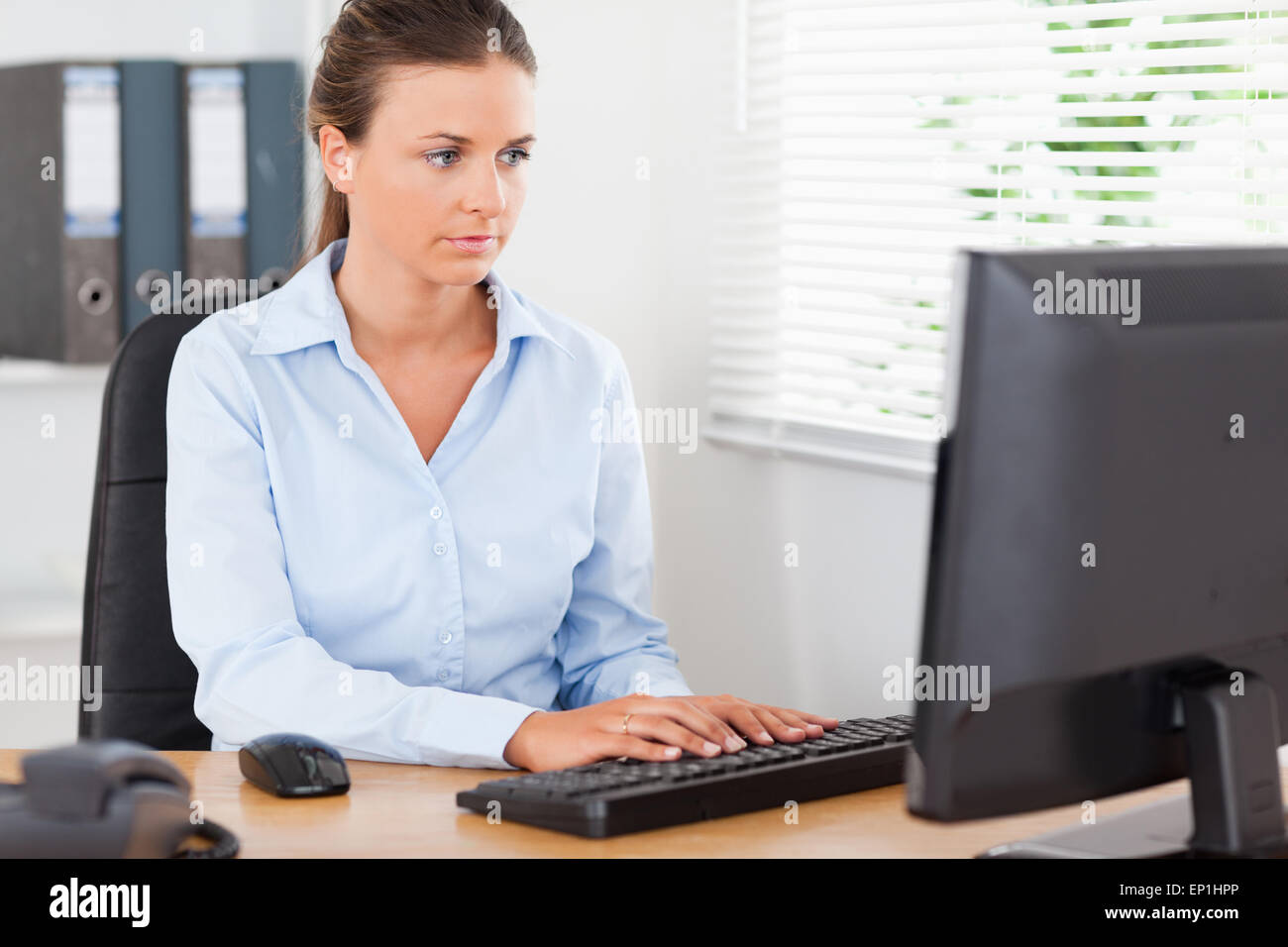 Businesswoman is typing in office Stock Photo - Alamy