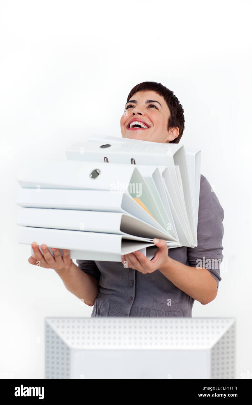 Laughing businesswoman carrying a pile of folders Stock Photo - Alamy