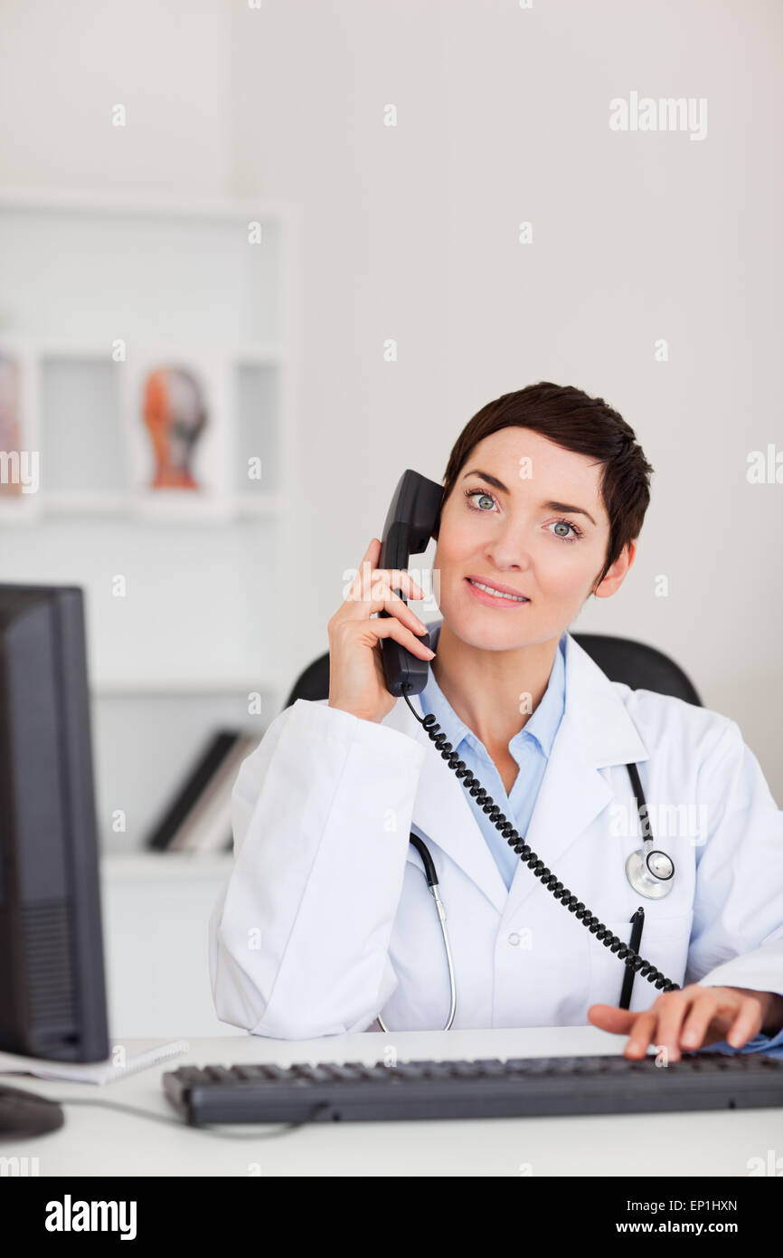 Portrait of a smiling female doctor making a phone call Stock Photo - Alamy