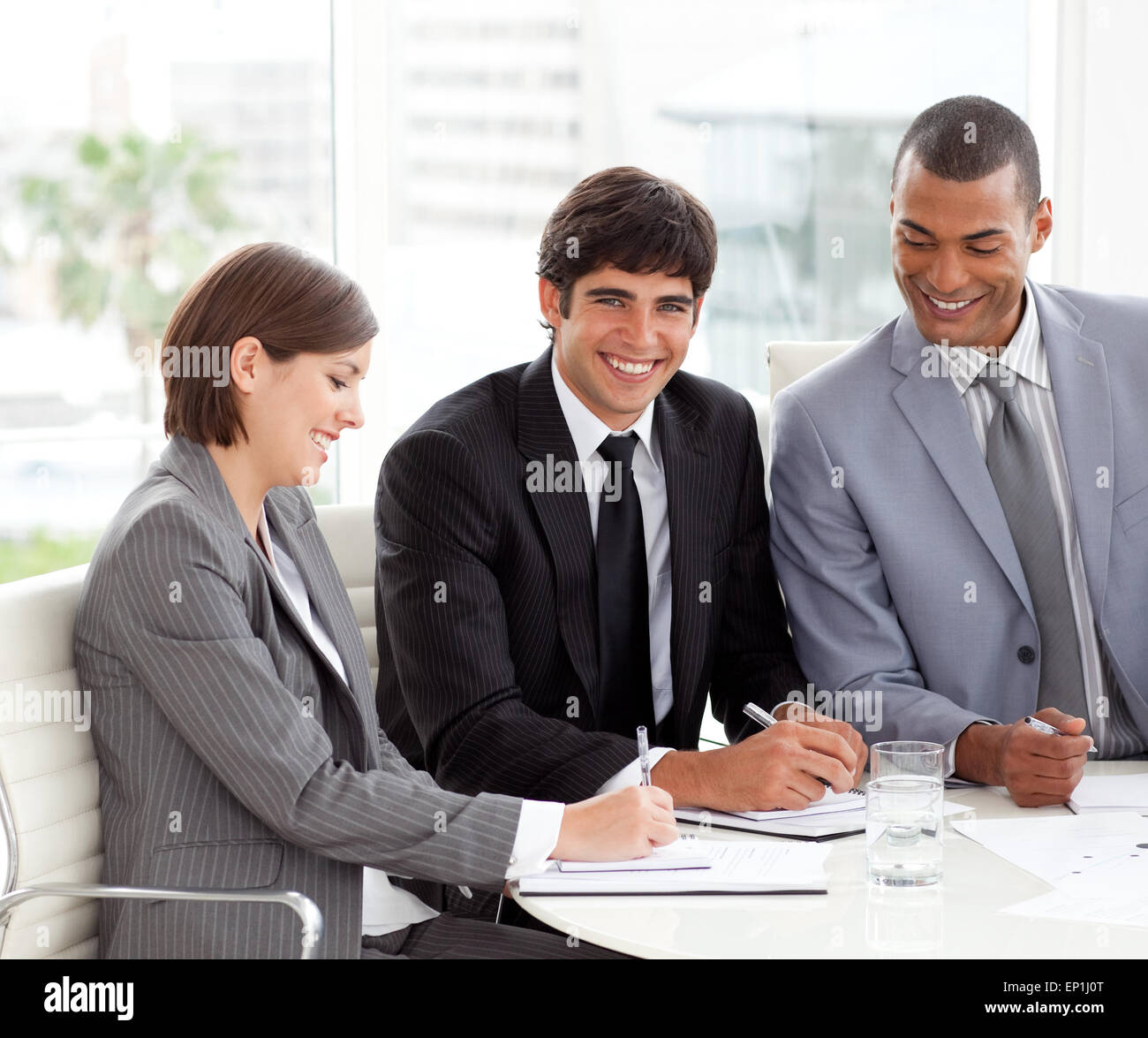 Attractive young businessman smiling at the camera in a meeting Stock ...