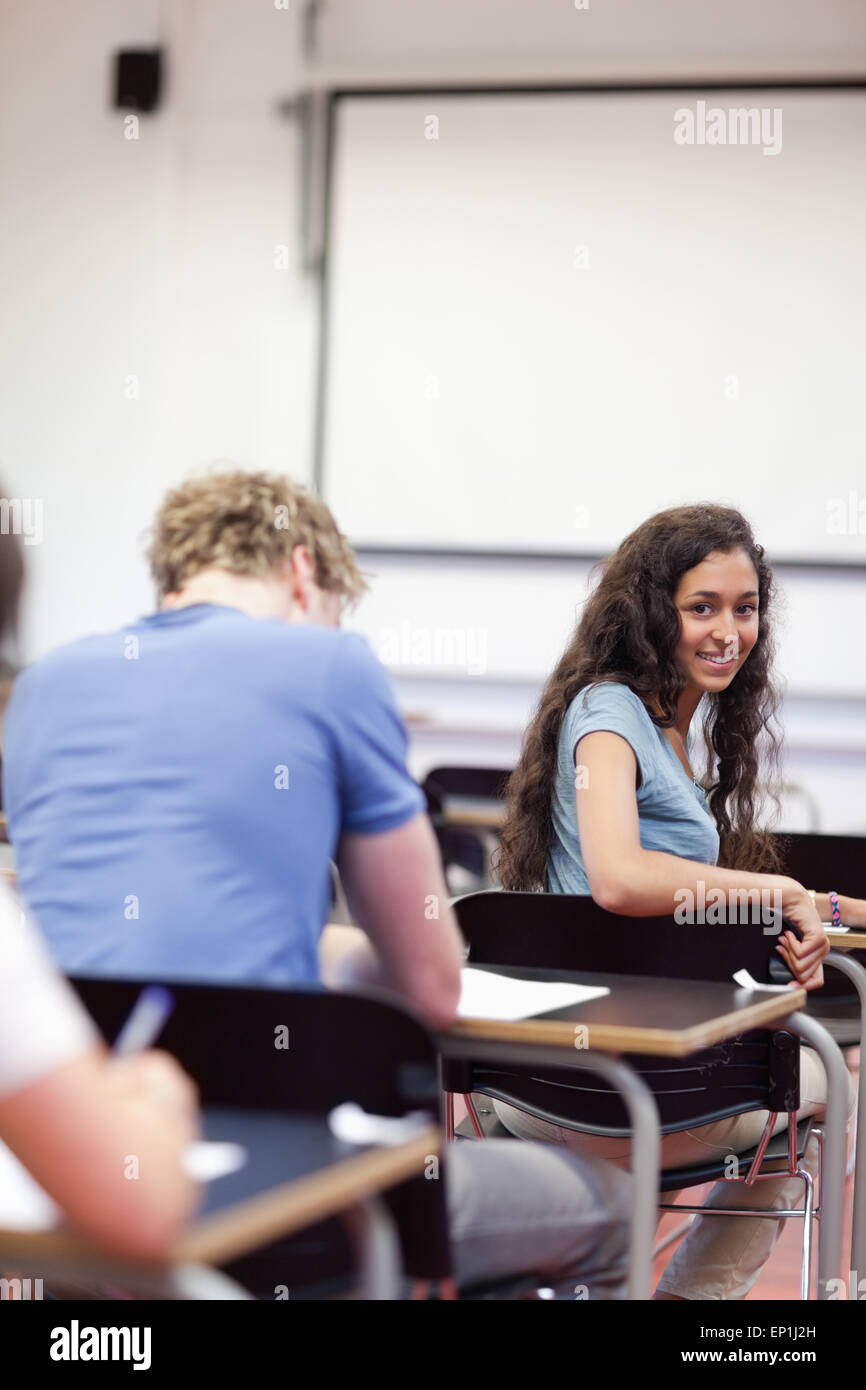 Portrait of a playful student sitting at a table Stock Photo - Alamy