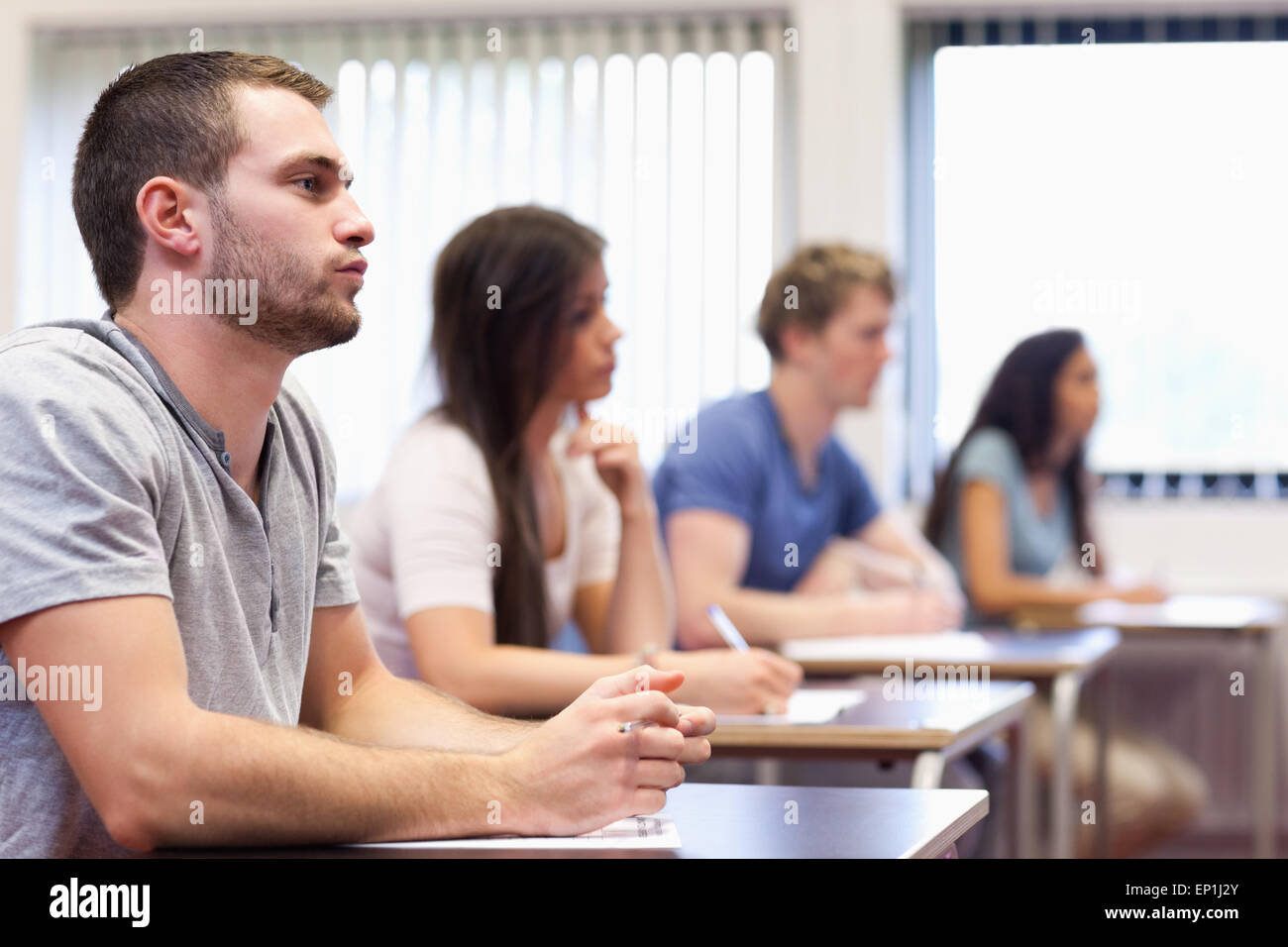 Handsome young man listening Stock Photo - Alamy