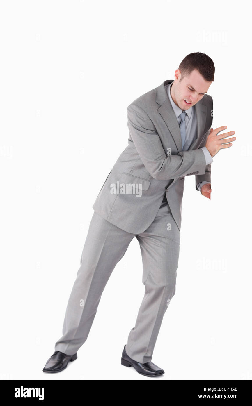 Portrait of a handsome businessman pushing a wall Stock Photo - Alamy