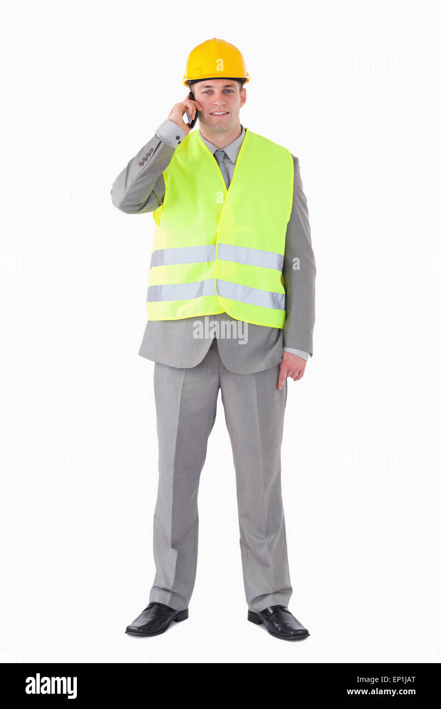 Portrait of a young builder making a phone call Stock Photo - Alamy
