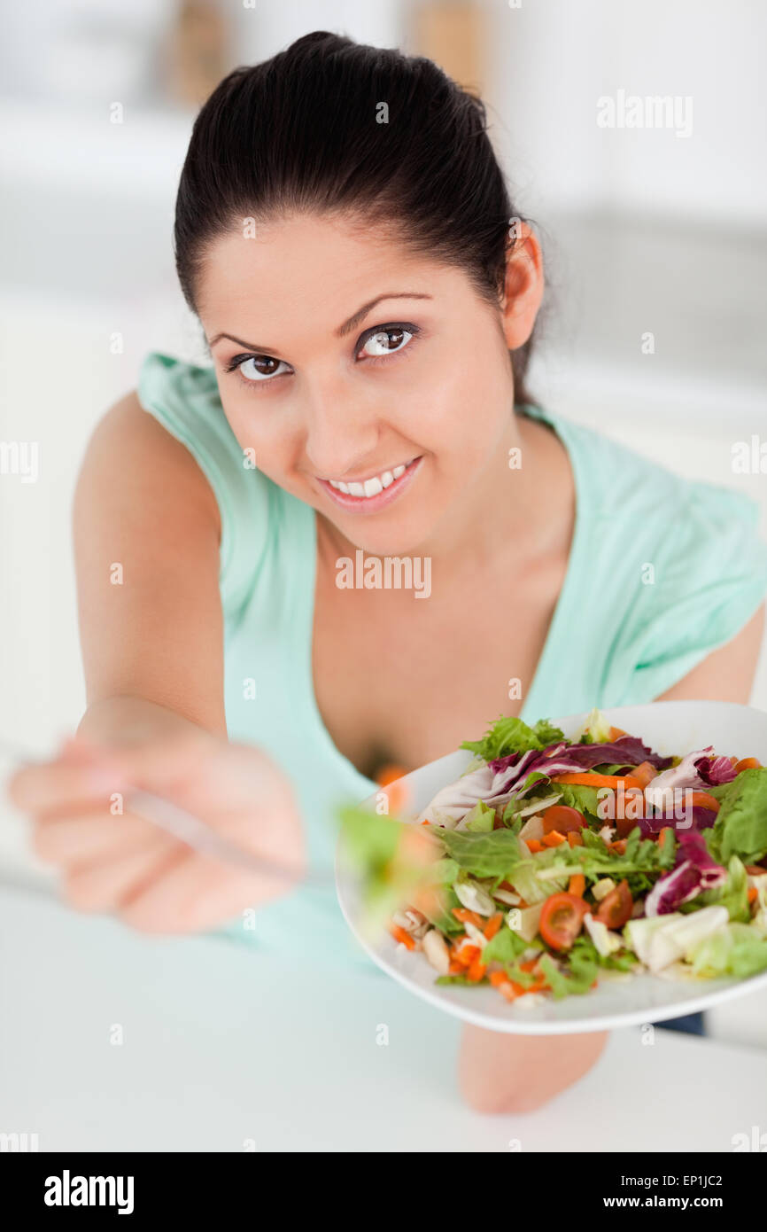 Cute young woman offering salad Stock Photo - Alamy