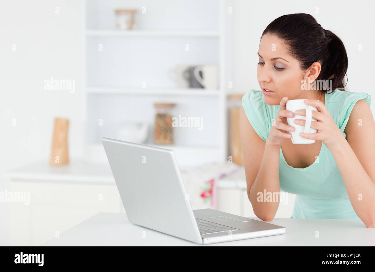 Lovely young woman looking to screen of laptop Stock Photo - Alamy