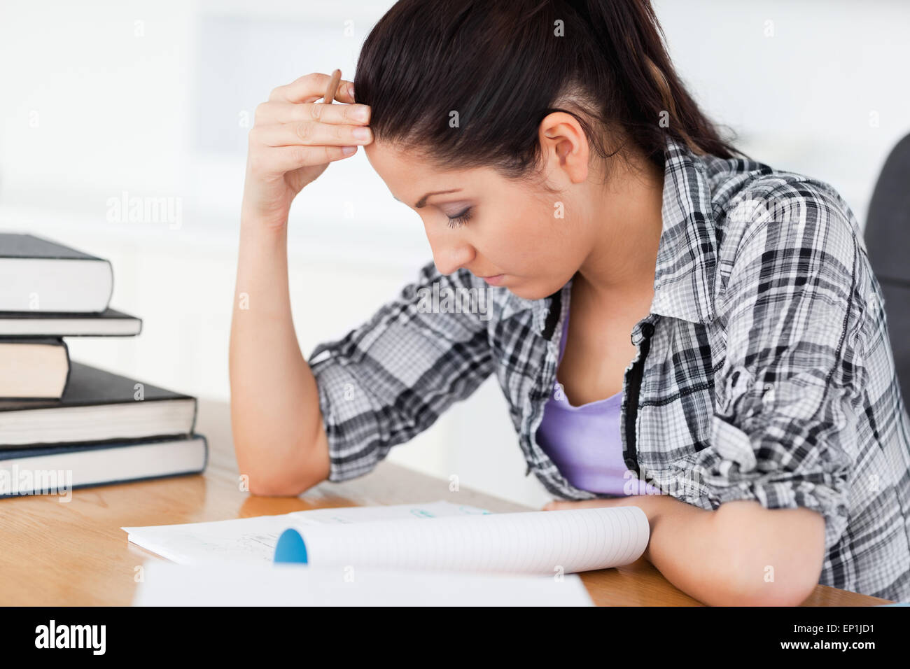 Young student thinking about her homework Stock Photo - Alamy