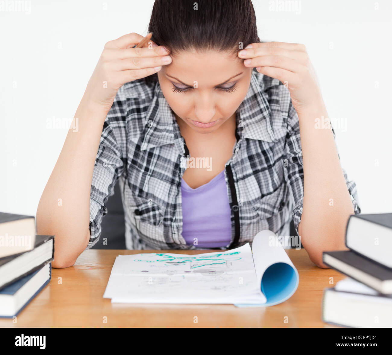 Stressed student doing her homework Stock Photo - Alamy