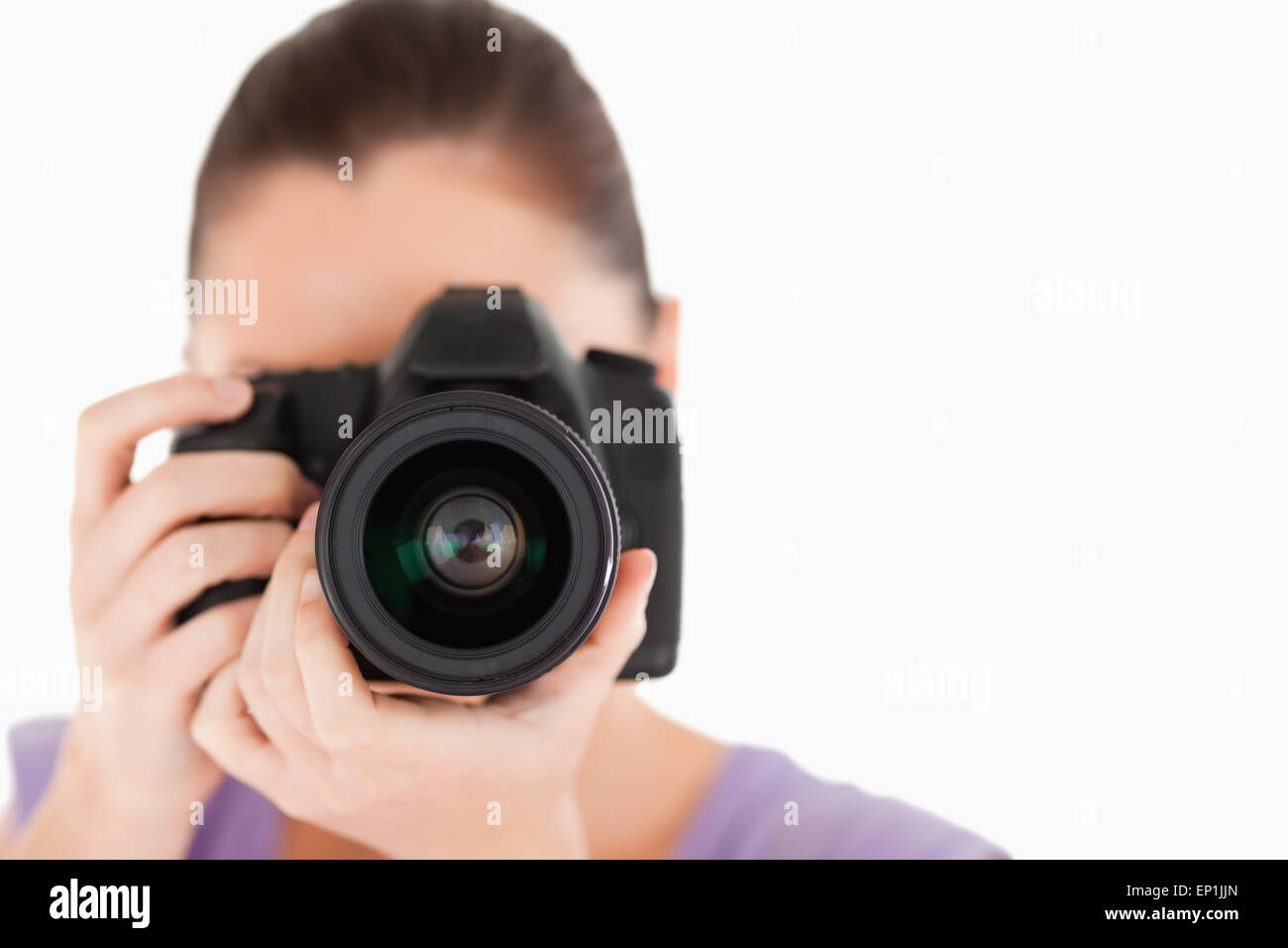 Good looking female using a camera while standing Stock Photo - Alamy