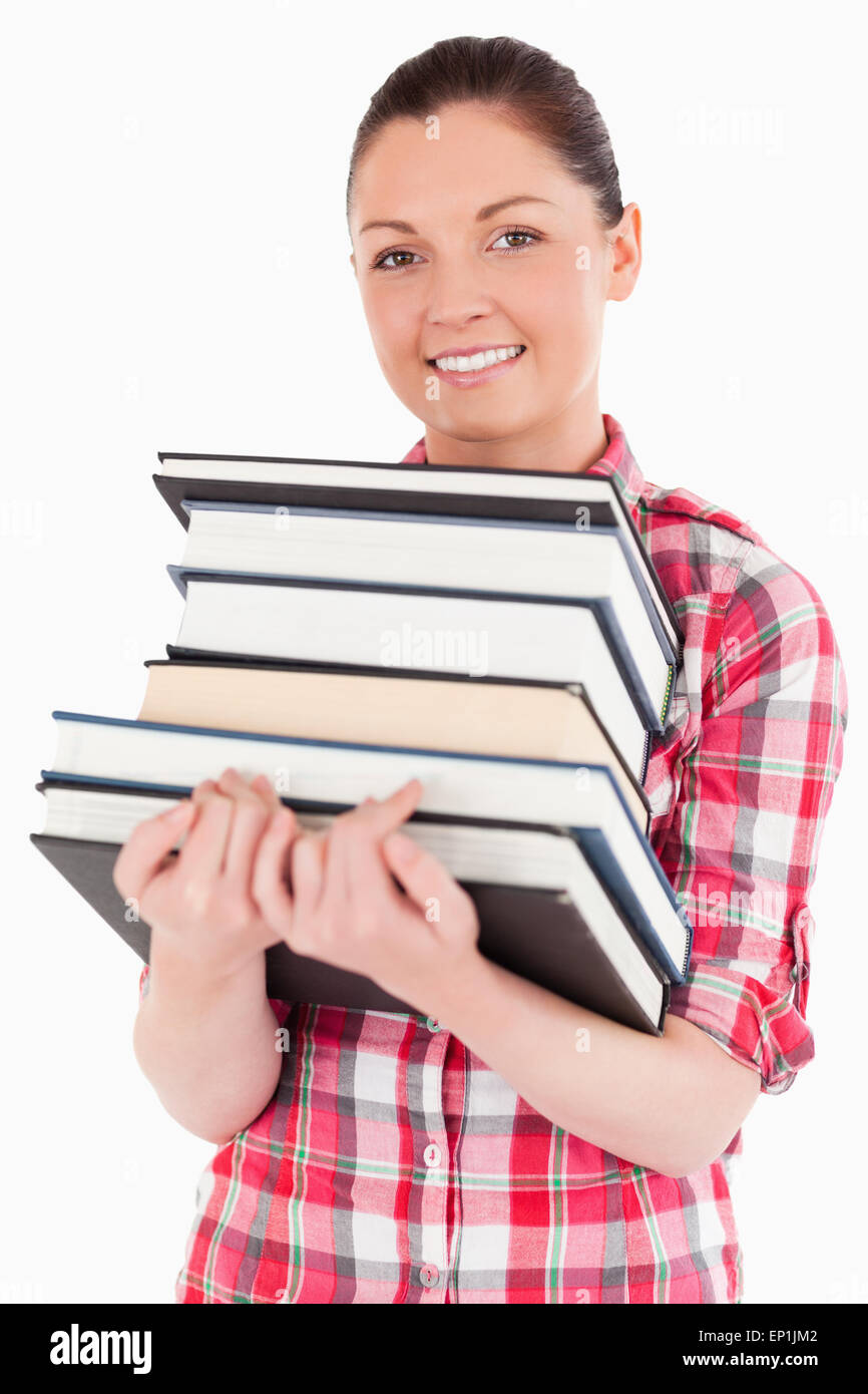 Charming female posing with books while standing Stock Photo - Alamy
