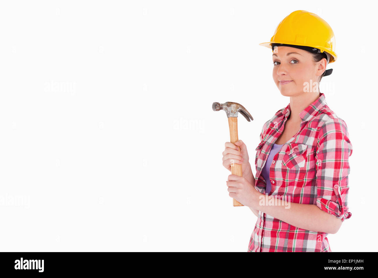 Beautiful woman holding a hammer while standing Stock Photo - Alamy